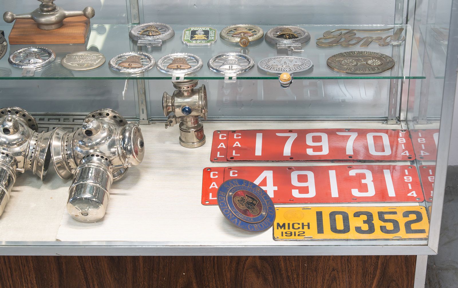 Assorted Car Club Badges, License Plates, and Steering Wheels | Gooding ...